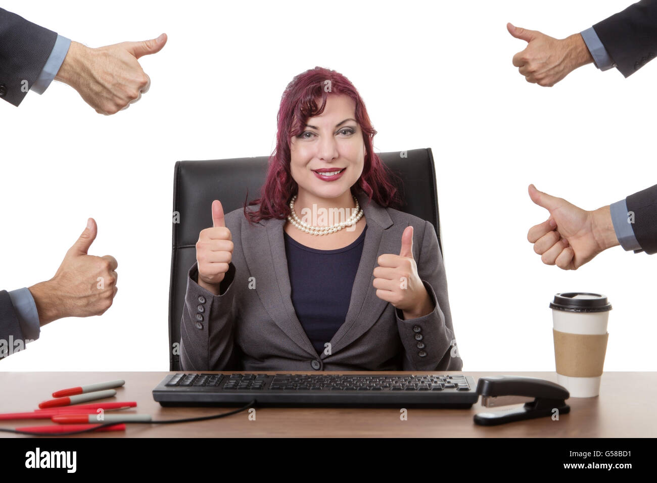 Happy woman sitting at her desk with her thumbs up with a mans thumb up ...