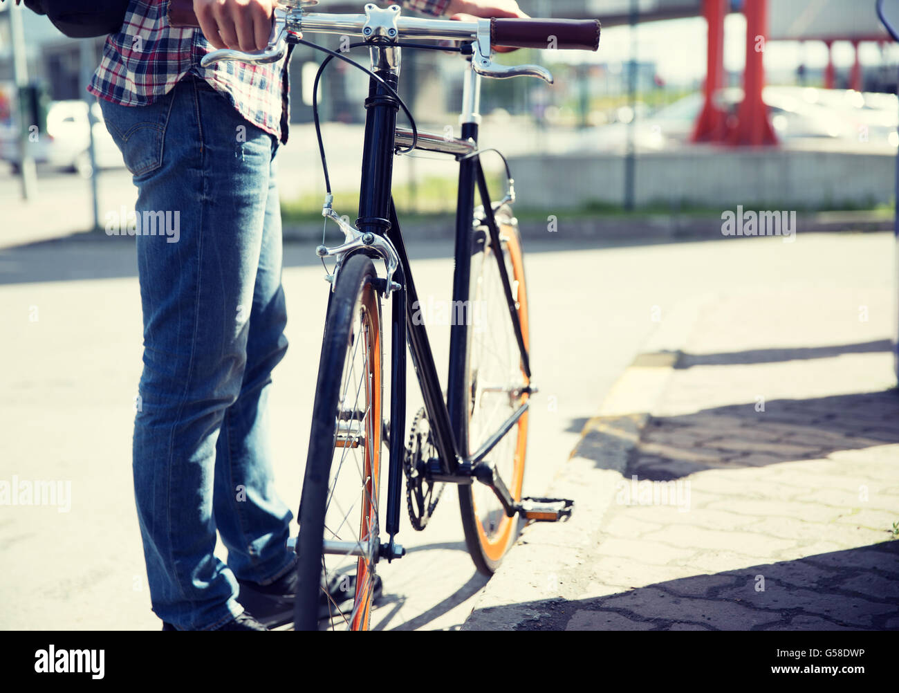 close up of man and fixed gear bike on city street Stock Photo - Alamy