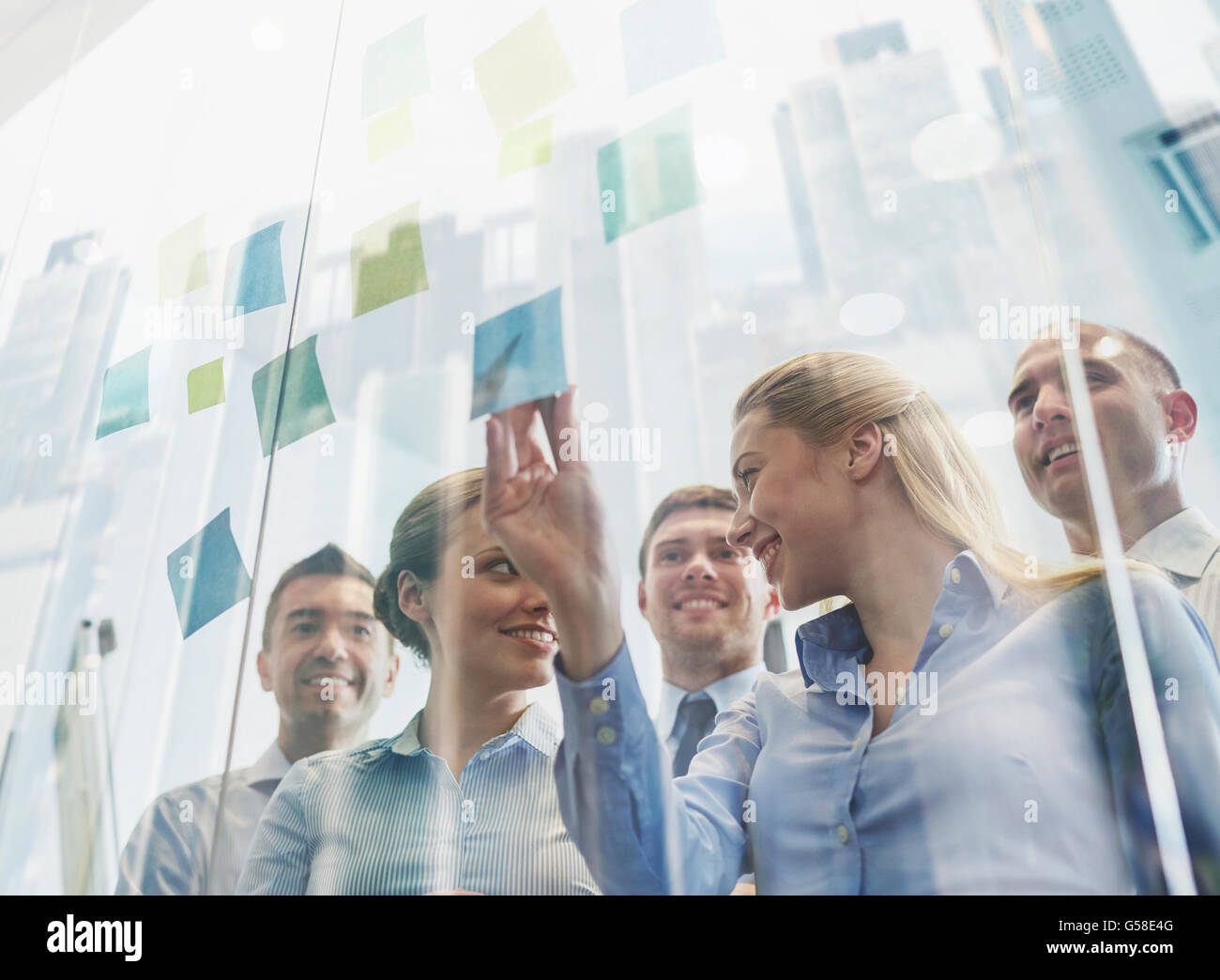 smiling business people with marker and stickers Stock Photo - Alamy