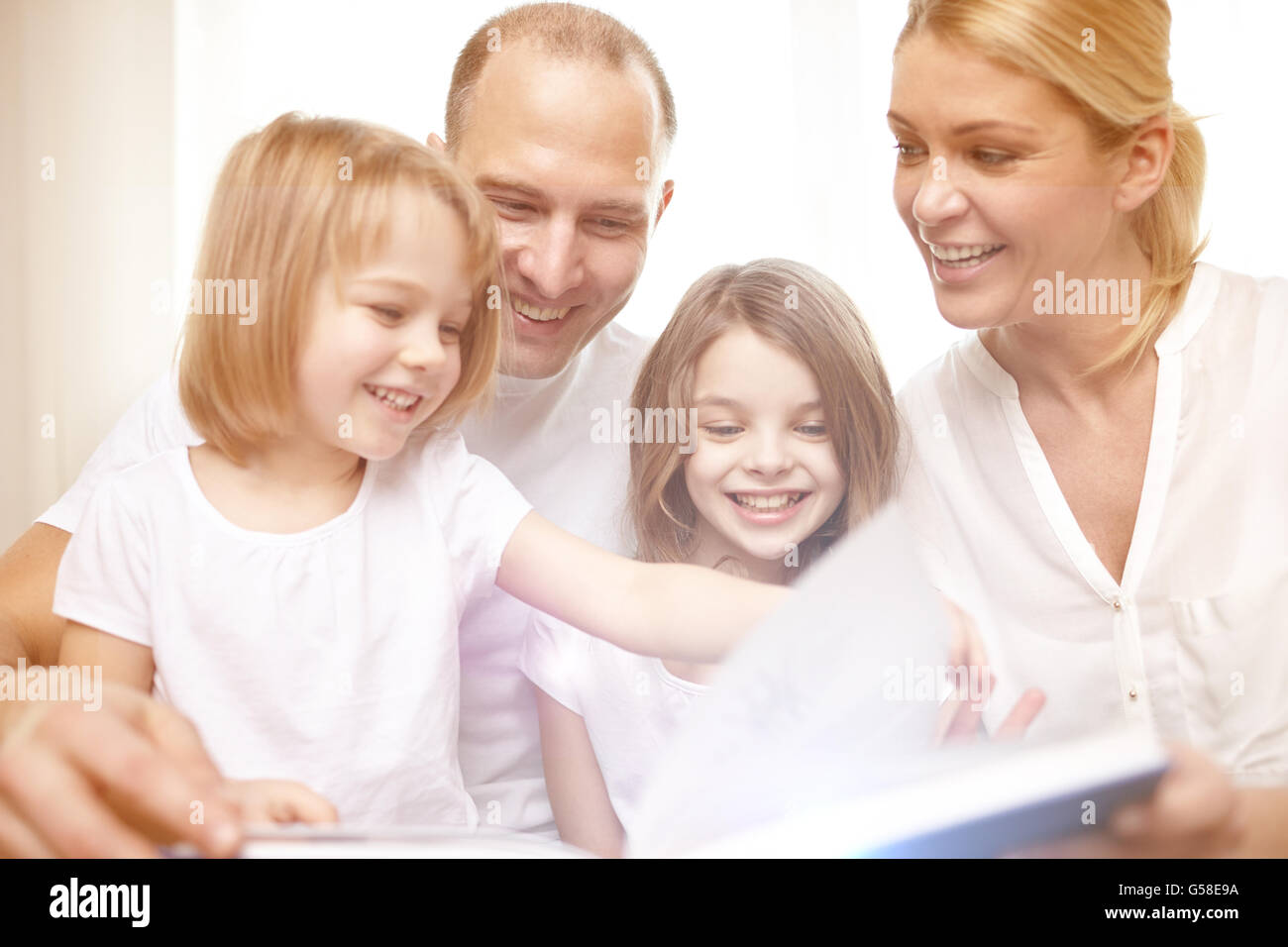 happy family reading book at home Stock Photo - Alamy