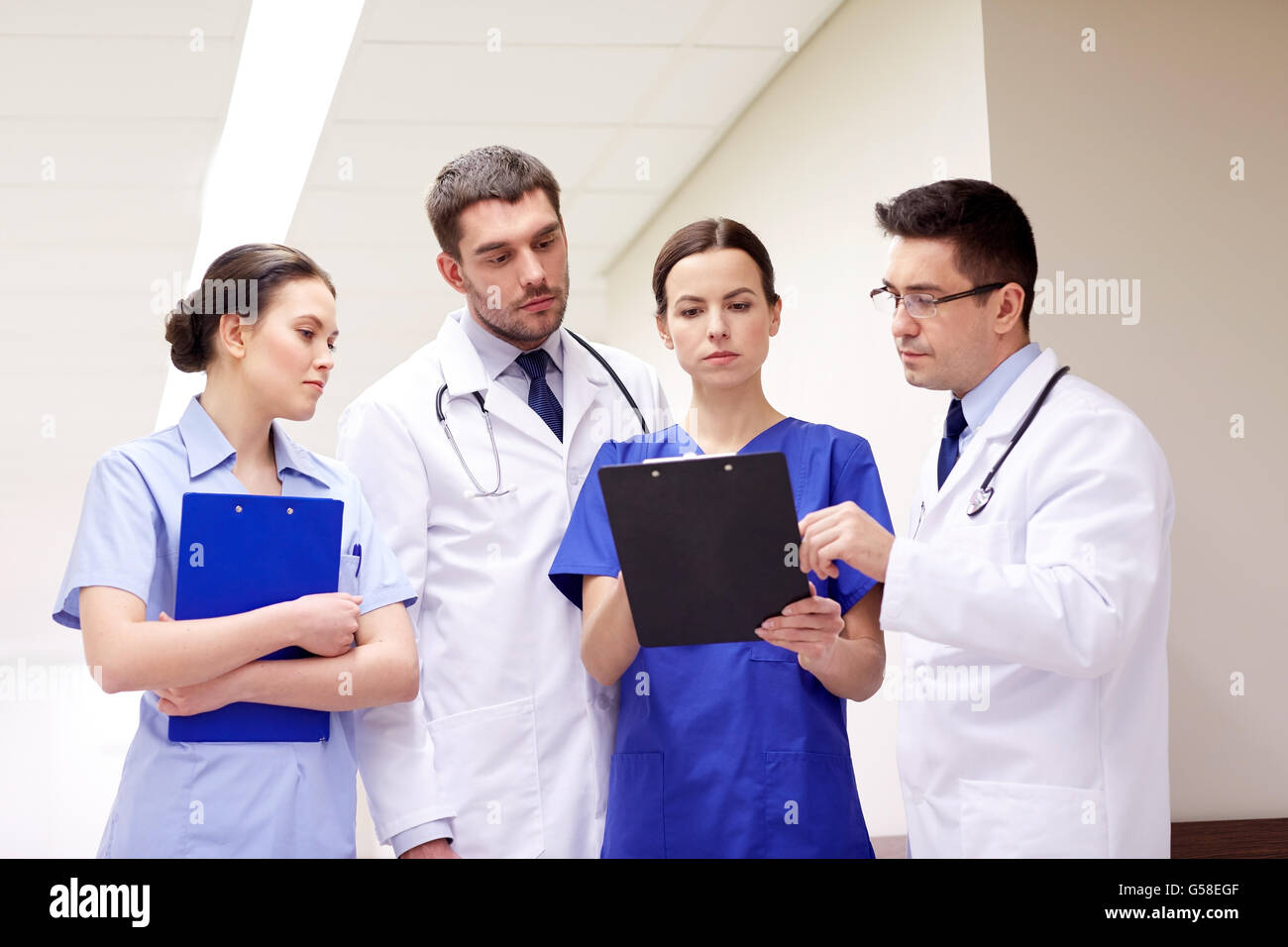 group of medics at hospital with clipboard Stock Photo - Alamy