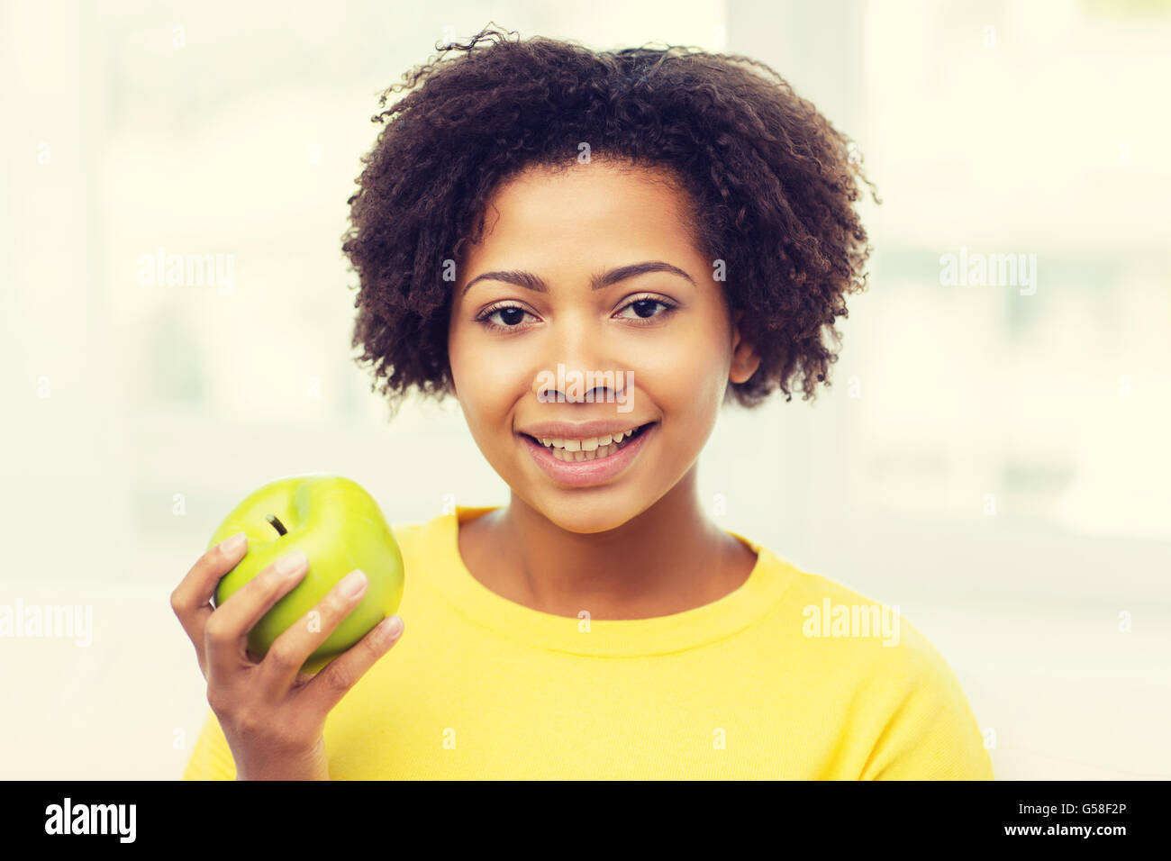 happy african american woman with green apple Stock Photo - Alamy