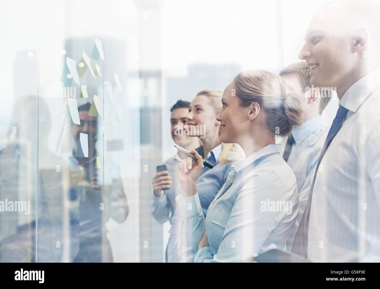smiling business people with marker and stickers Stock Photo - Alamy