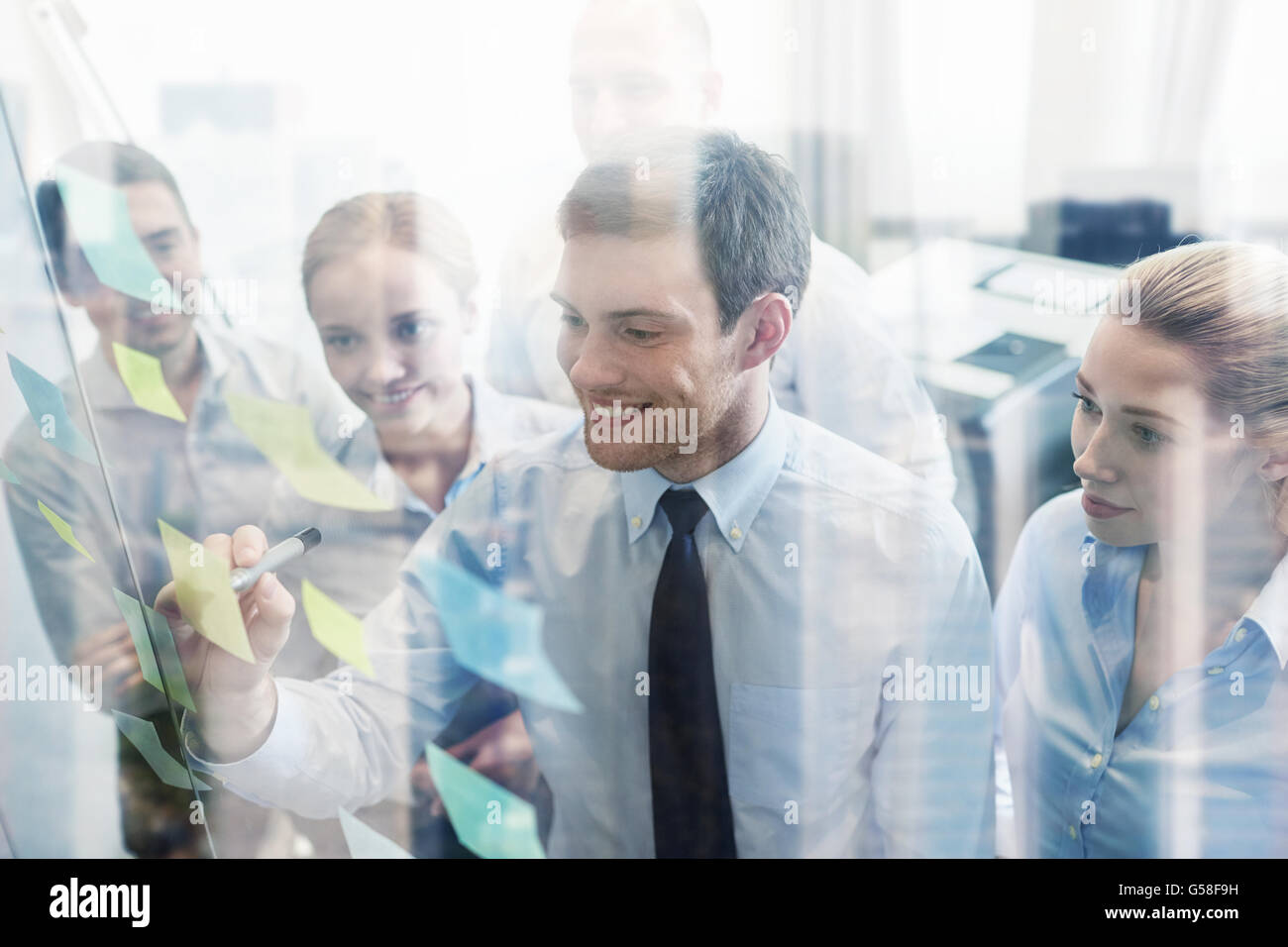 smiling business people with marker and stickers Stock Photo - Alamy