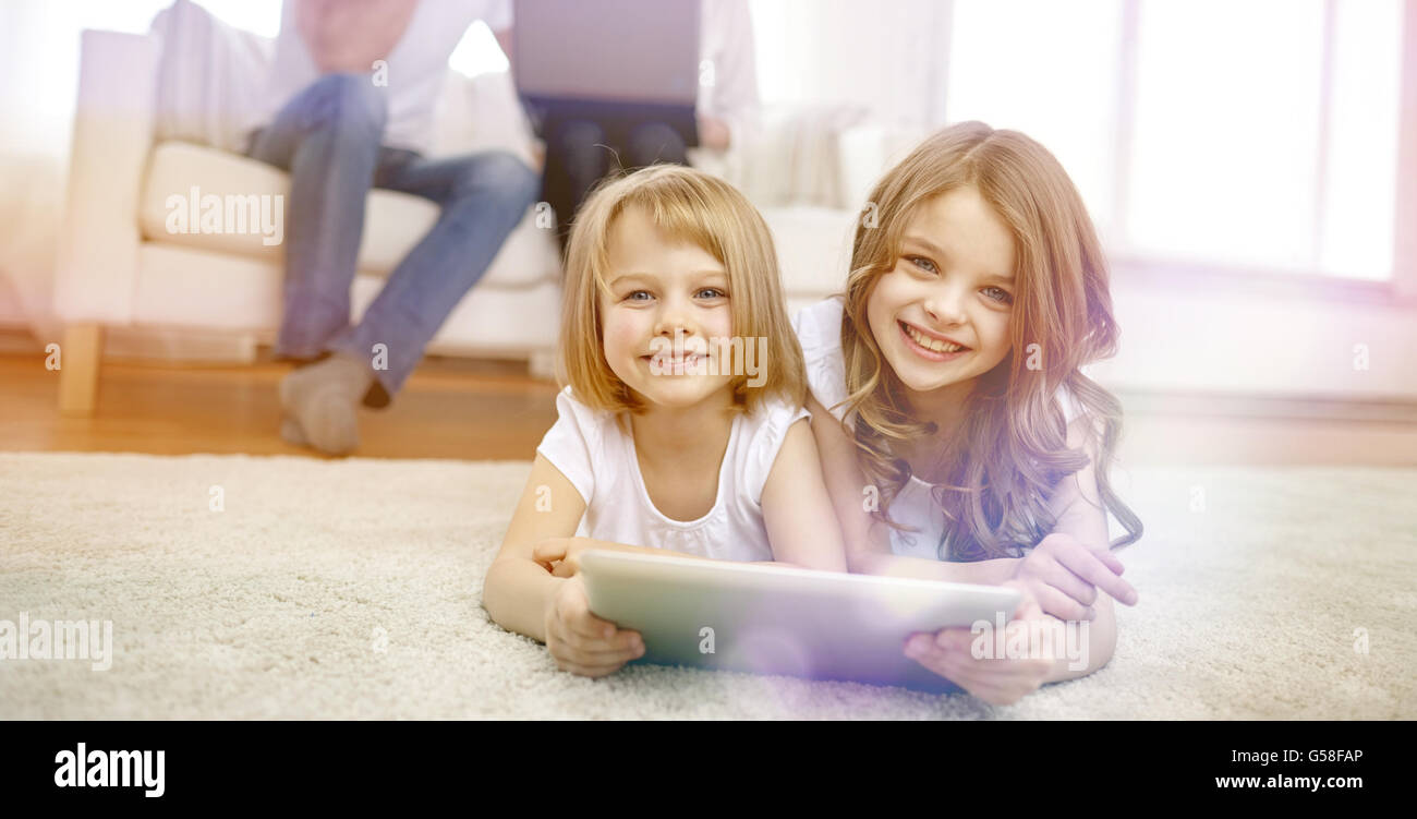 happy little girls with tablet pc computer at home Stock Photo - Alamy