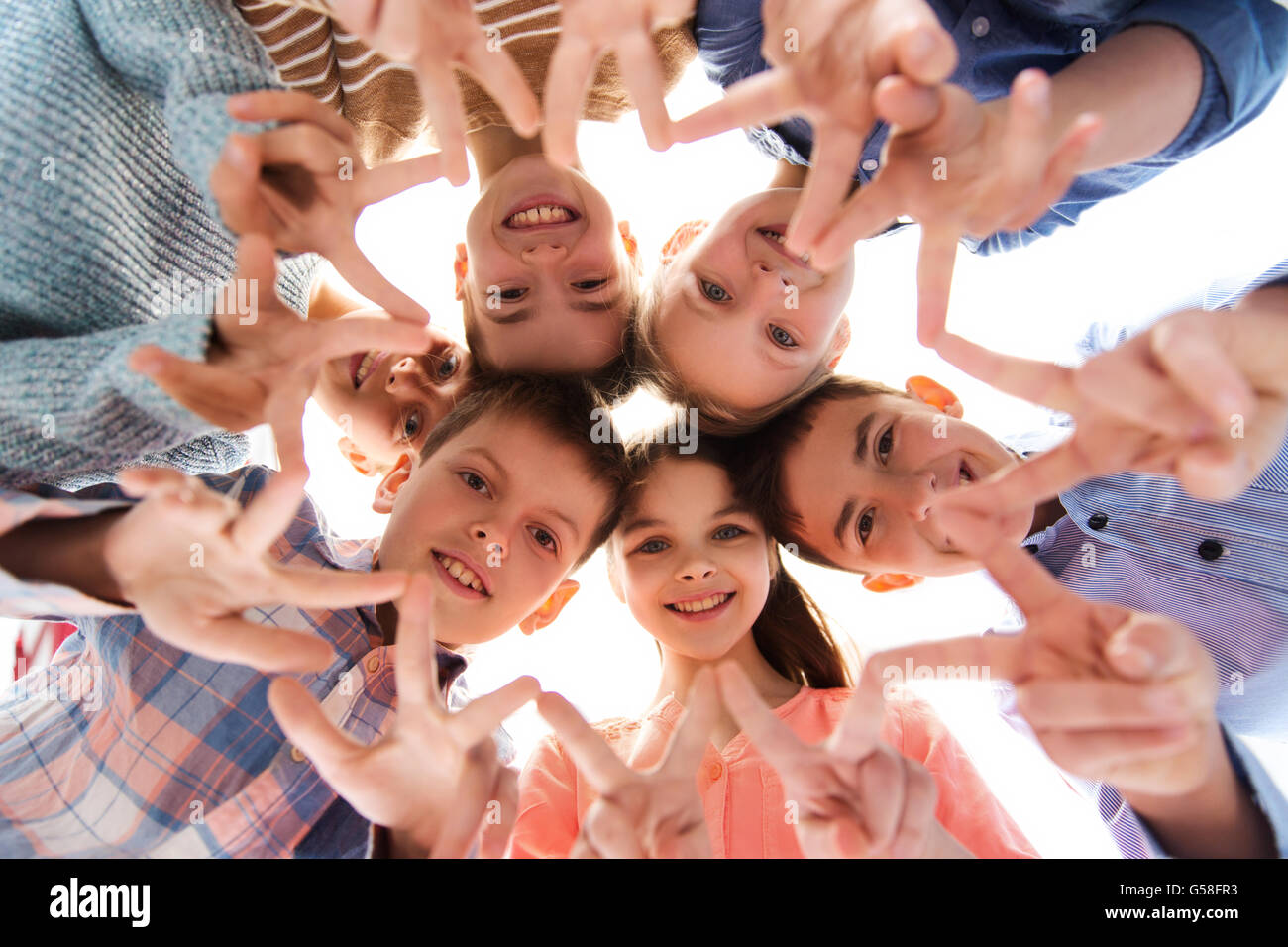 happy children showing peace hand sign Stock Photo - Alamy