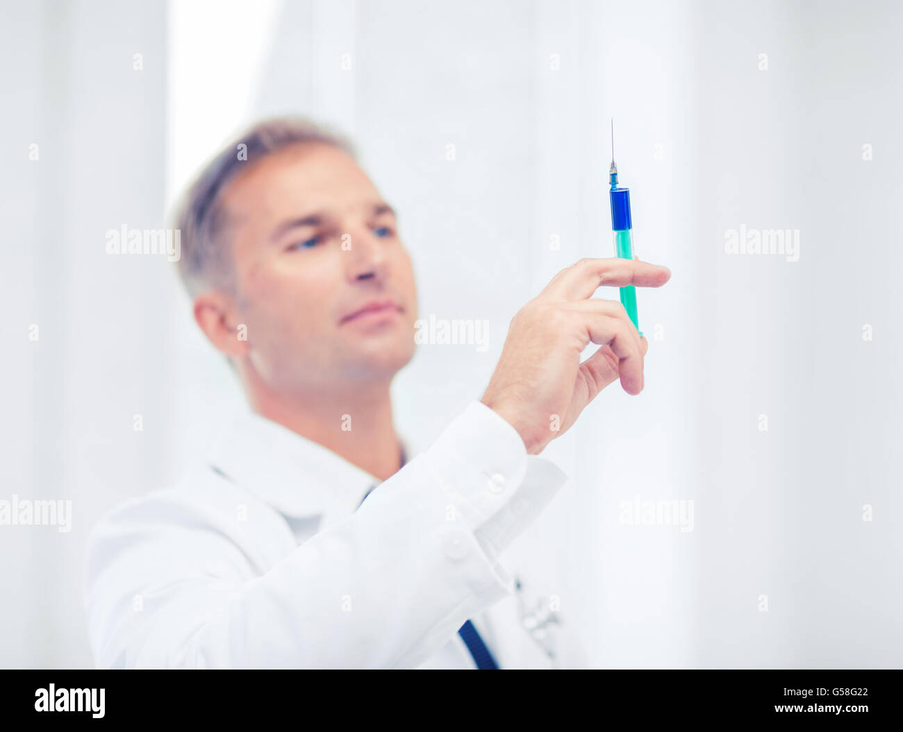 male doctor holding syringe with injection Stock Photo - Alamy