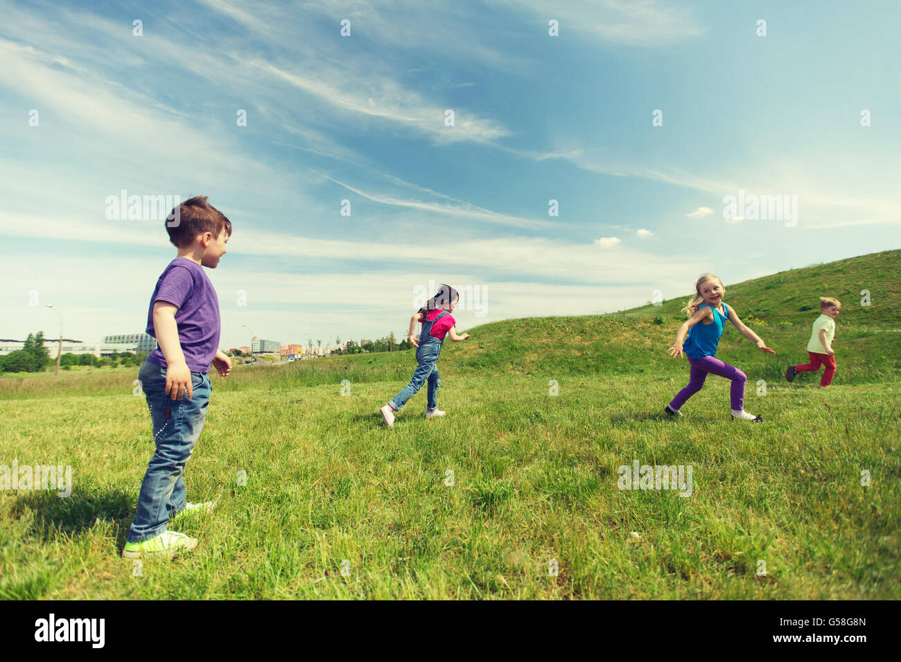 group of happy kids running outdoors Stock Photo - Alamy