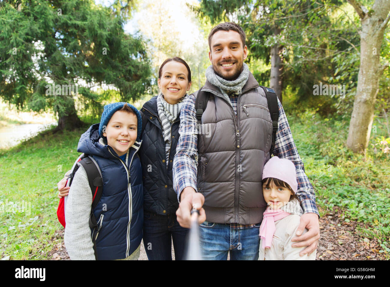 family with backpacks taking selfie and hiking Stock Photo - Alamy
