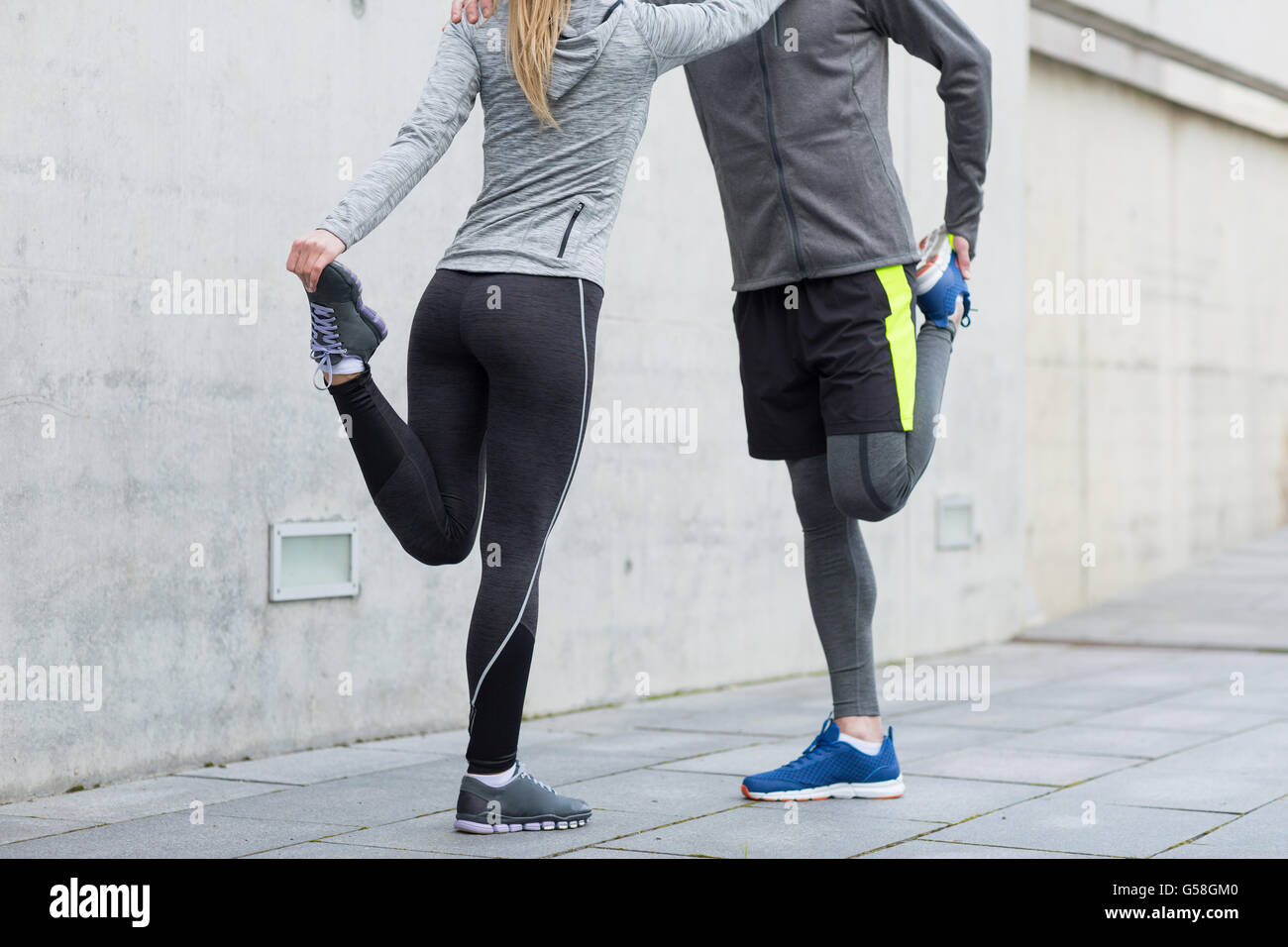 close up of couple stretching legs outdoors Stock Photo - Alamy