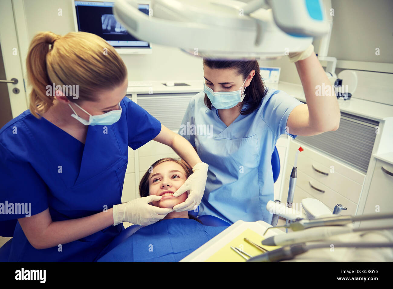 happy female dentist with patient girl at clinic Stock Photo - Alamy