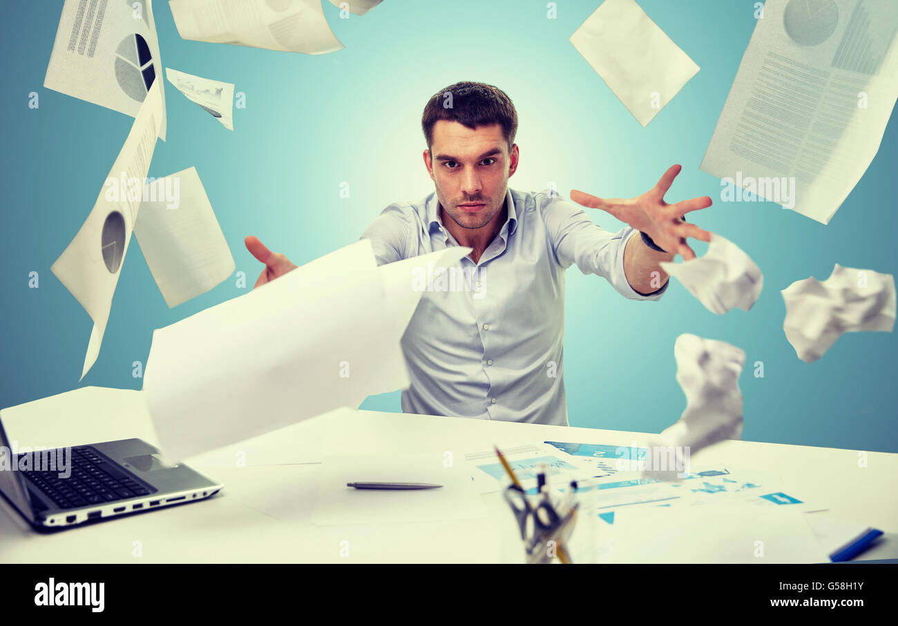 angry businessman throwing papers in office Stock Photo - Alamy