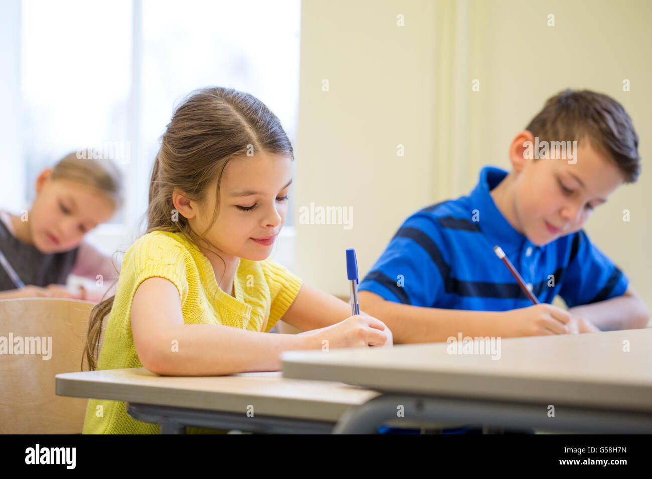 group of school kids writing test in classroom Stock Photo - Alamy