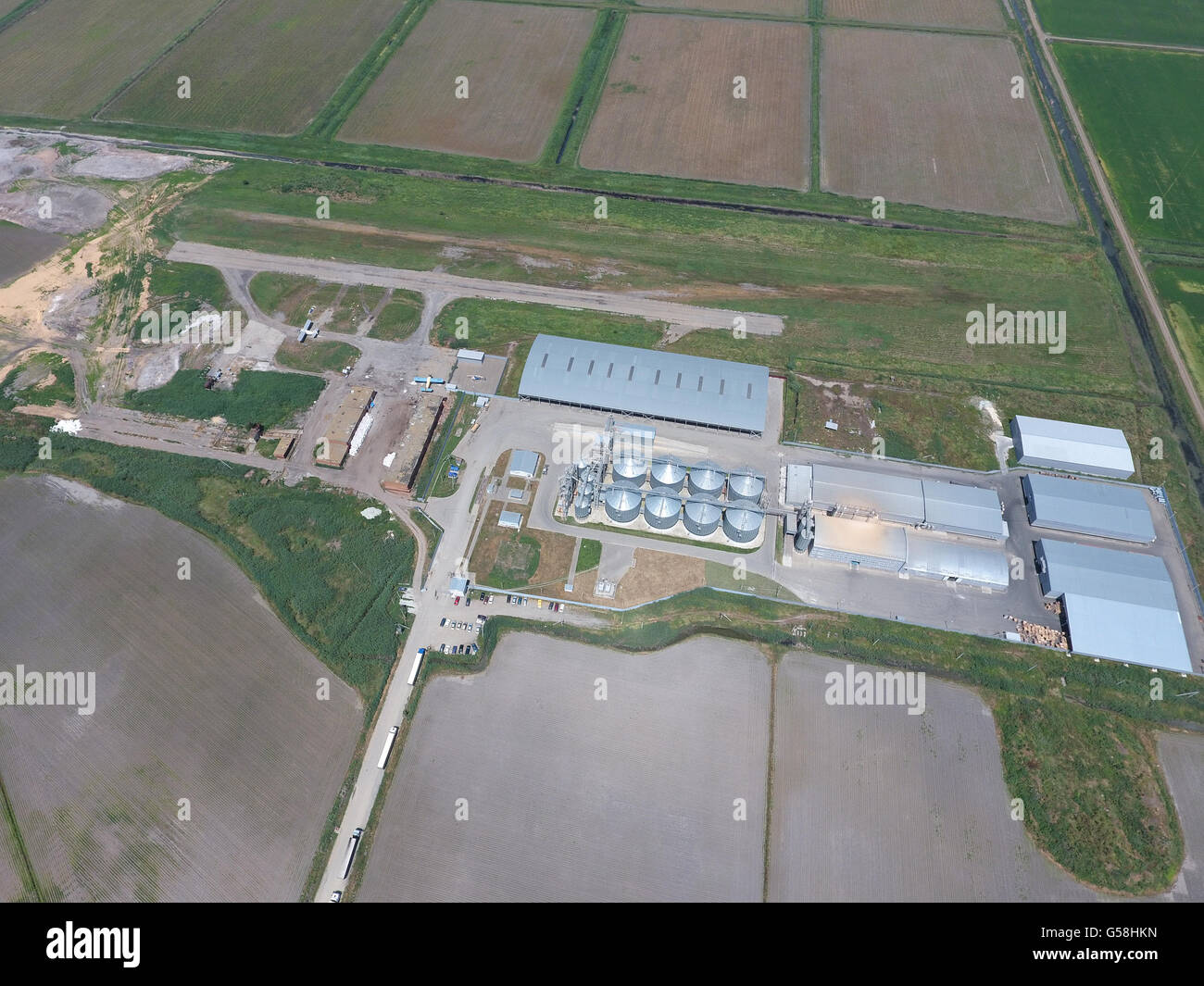 Plant for the drying and storage of grain. Rice plant in the middle of ...