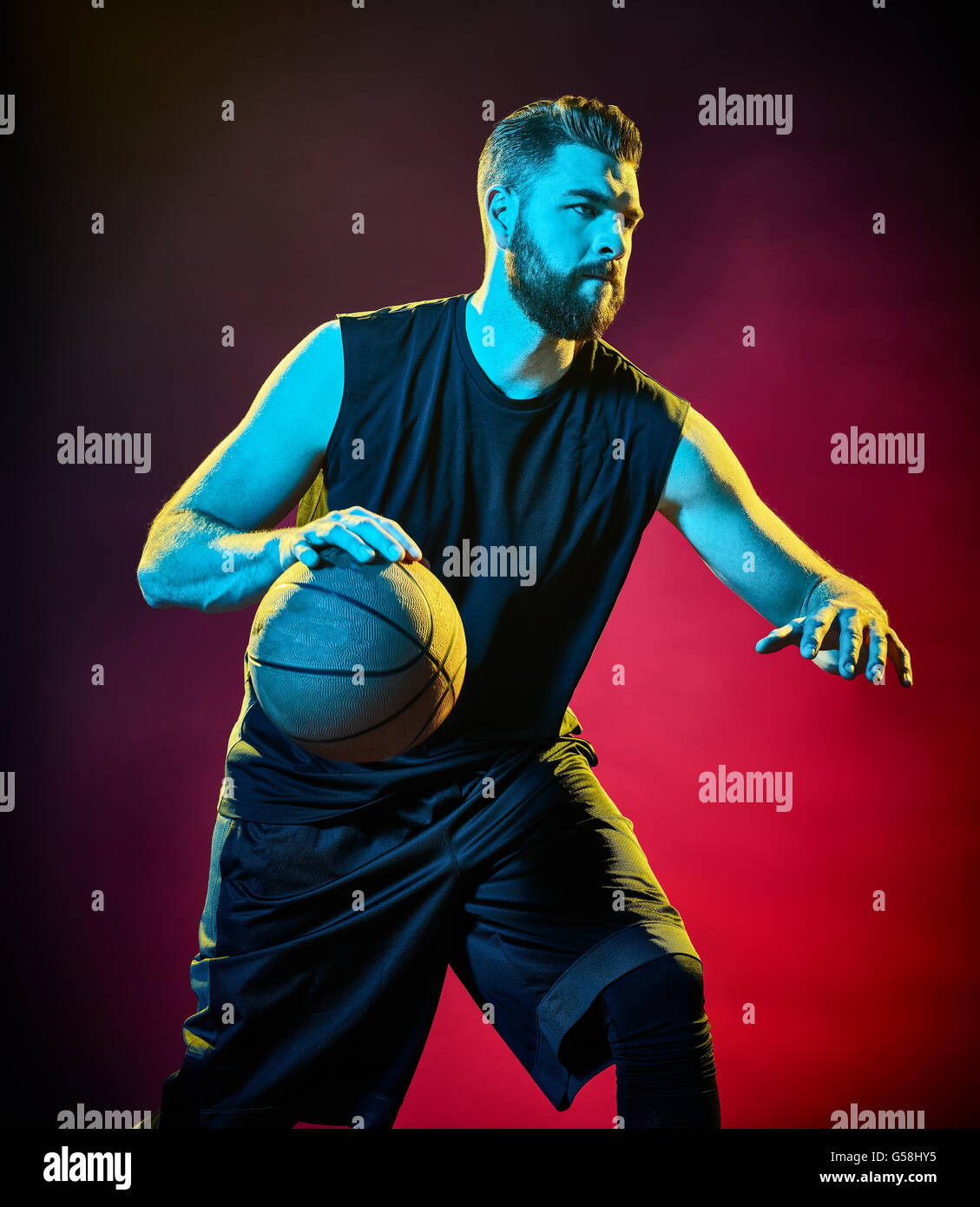 one basketball player man Isolated on black background Stock Photo - Alamy