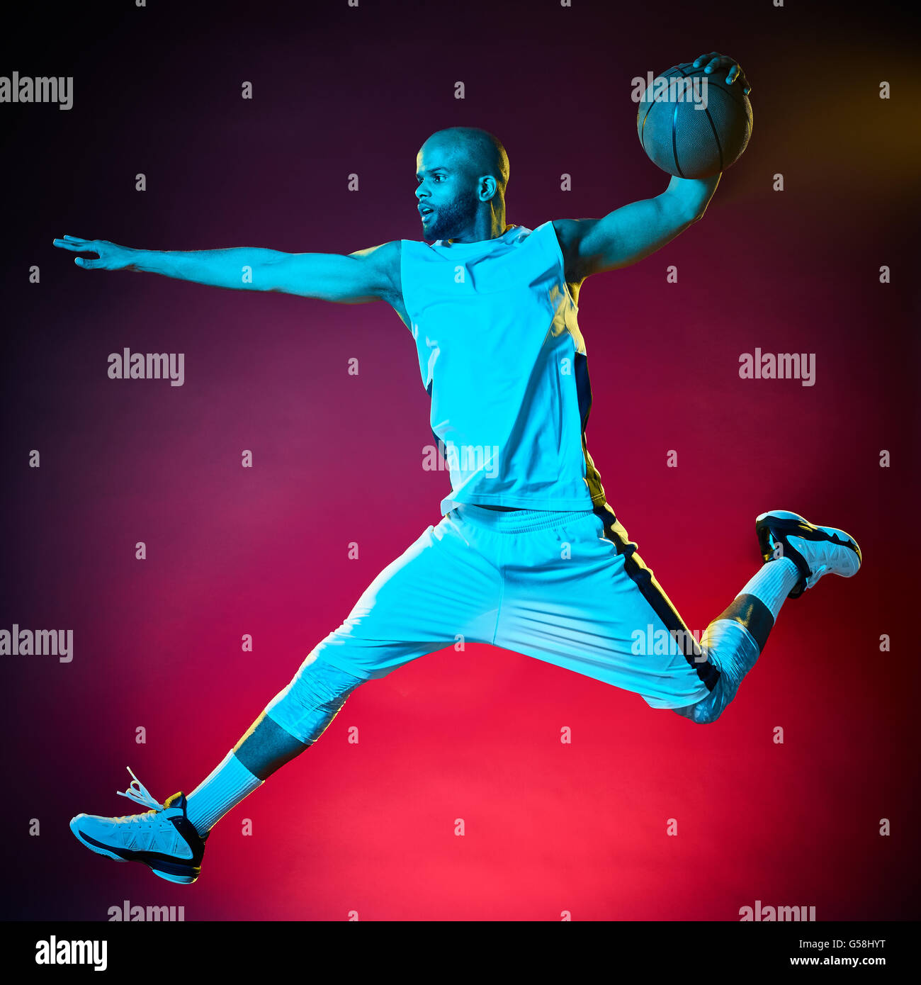one basketball player man Isolated on black background Stock Photo - Alamy