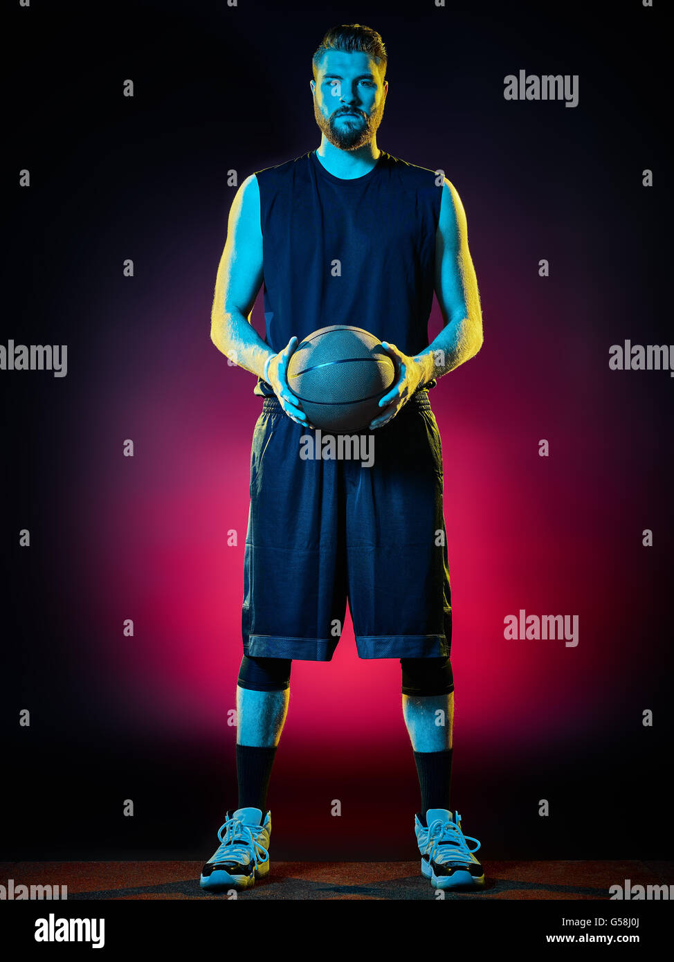 one basketball player man Isolated on black background Stock Photo - Alamy