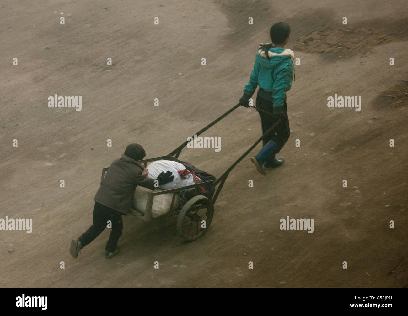 Children pushing a cart hi-res stock photography and images - Alamy