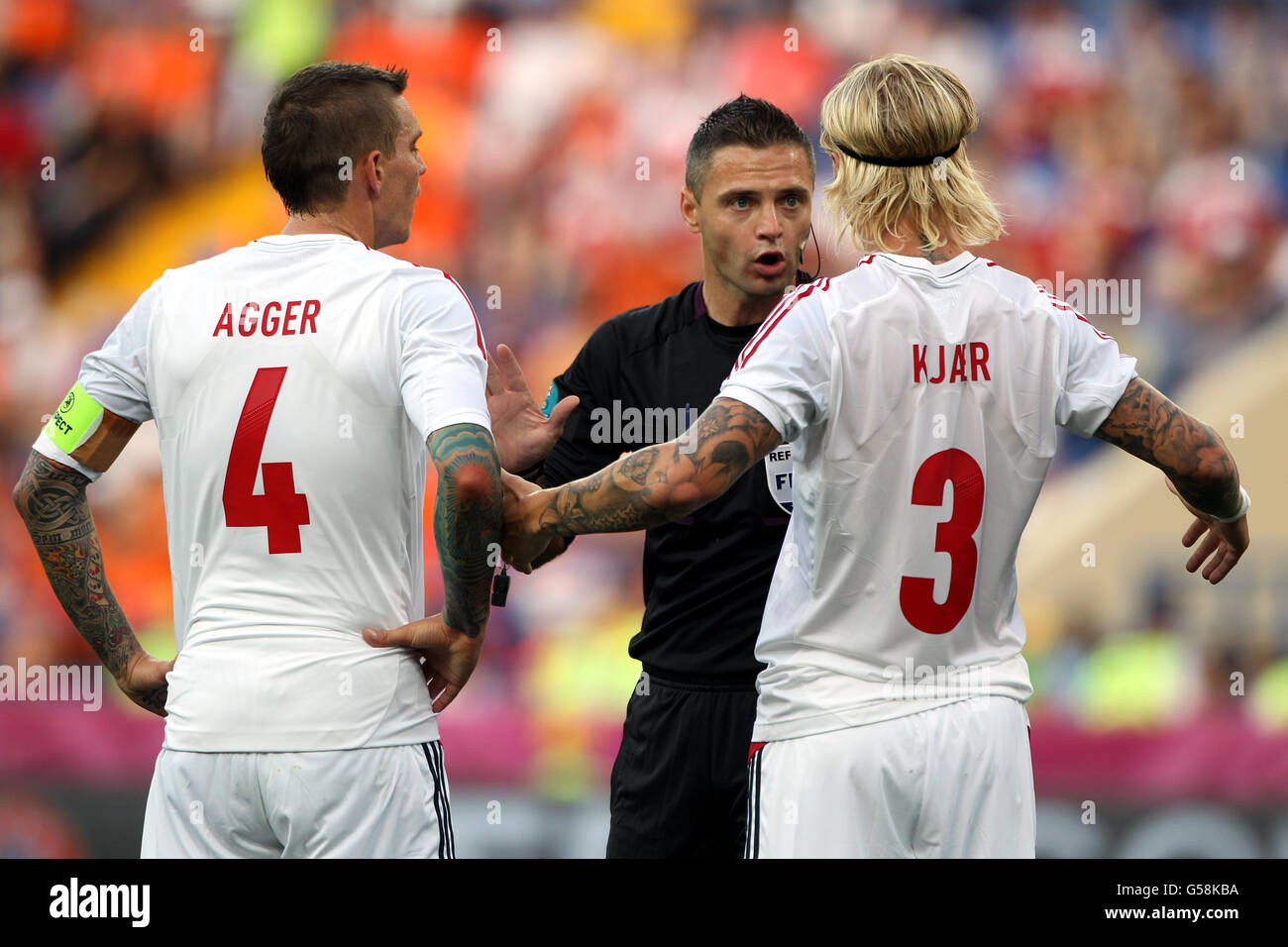 Referee damir skomina talks with denmarks daniel agger l hi-res stock ...