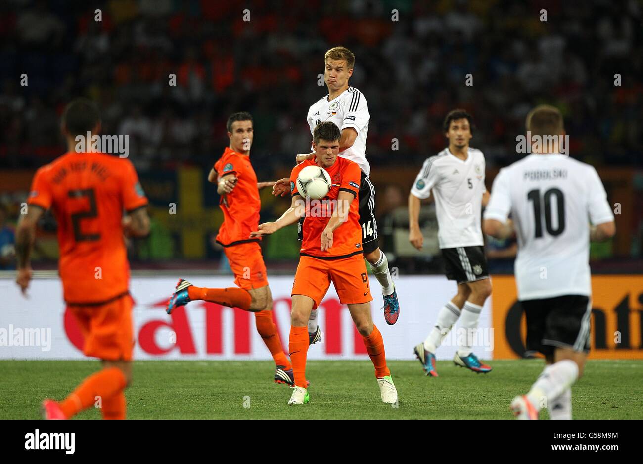Netherlands' Klaas-Jan Huntelaar (front) and Germany's Lars Bender ...