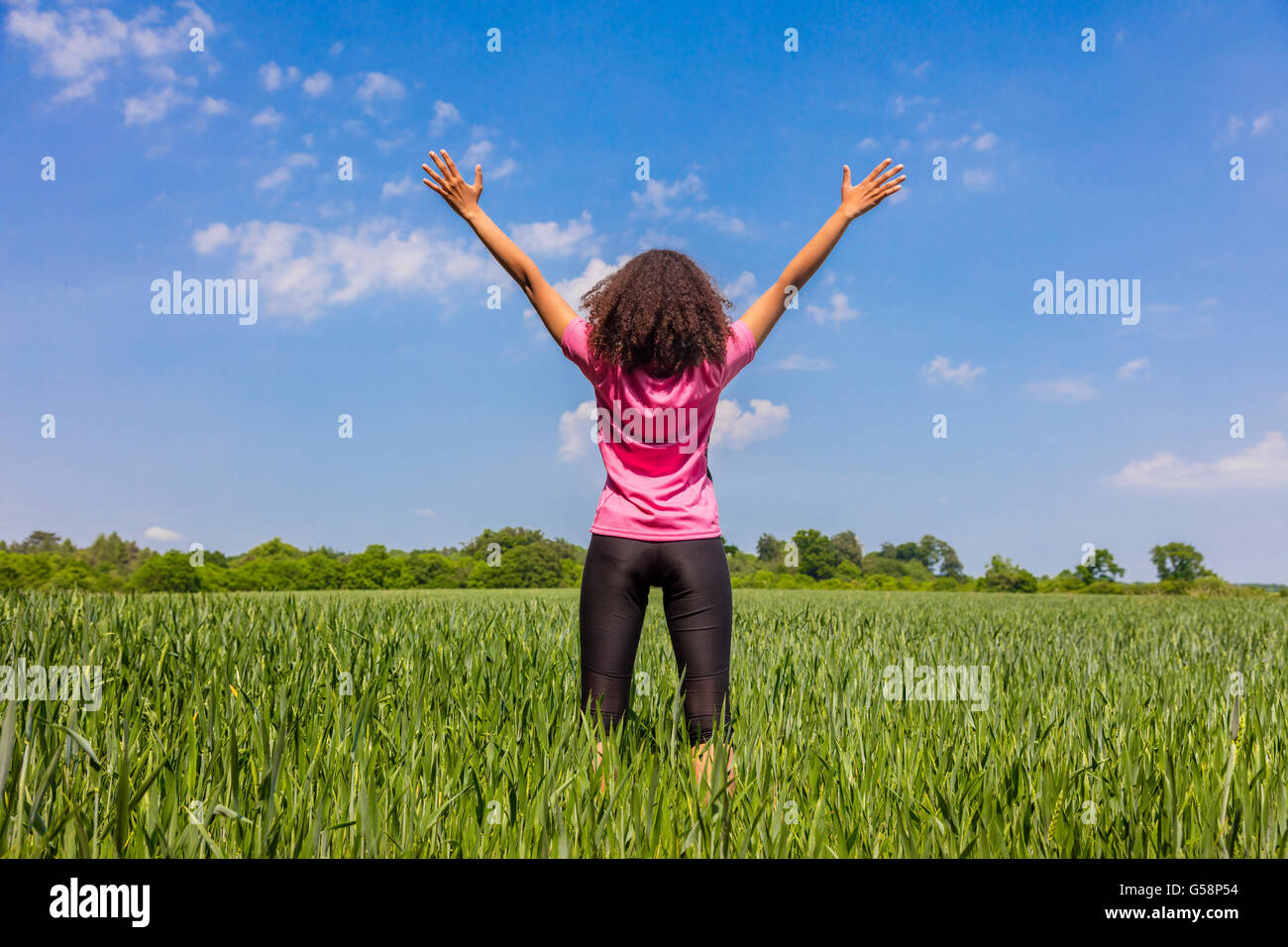 Woman arms raised rear view sky hi-res stock photography and images - Alamy