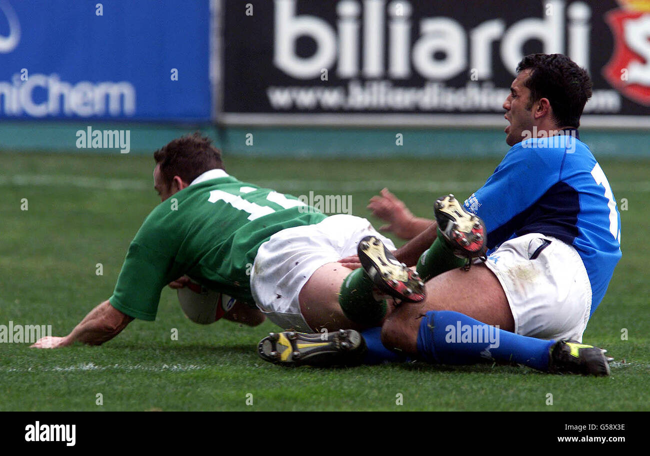 Ireland's Rob Henderson (left) scores the first try despite a tackle ...