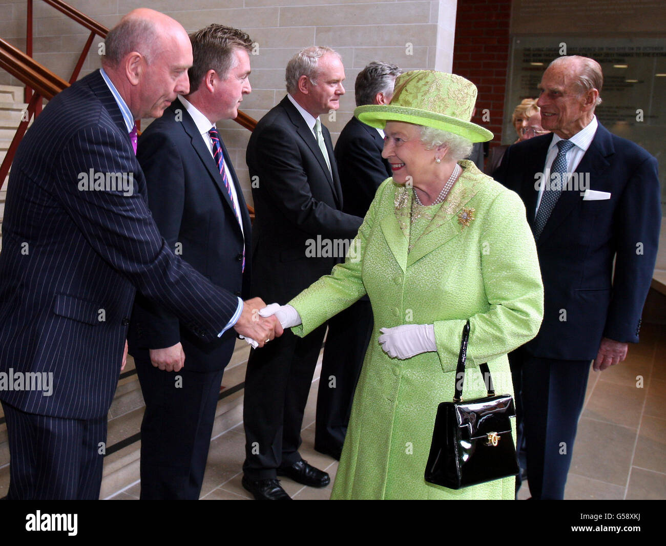 Queen Elizabeth II shakes hands with Peter Sheridan from Co-operation ...