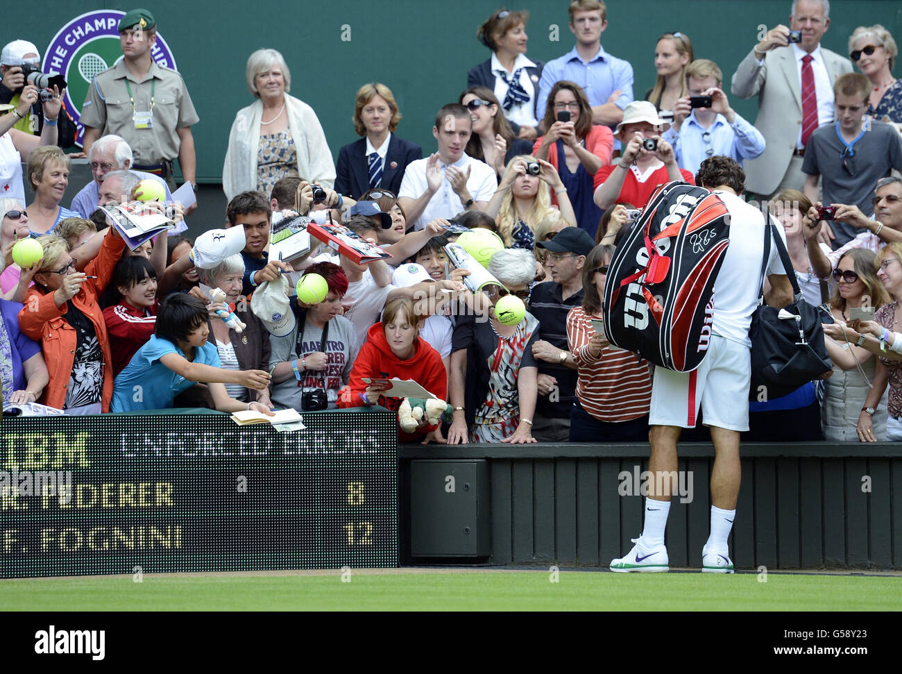 Switzerland's Roger Federer signs autographs following his victory over ...