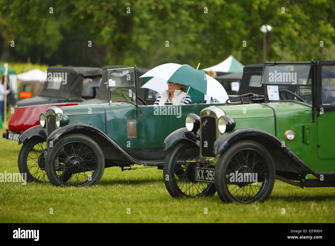 A woman shelters under an umberella in her Austin Seven Tourer 'Chummy ...