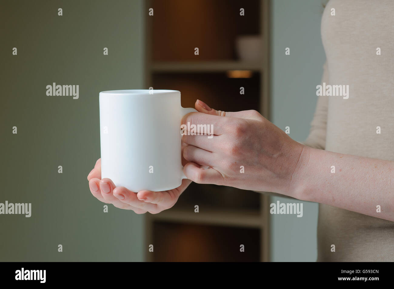 White cup in hand of a girl Stock Photo - Alamy