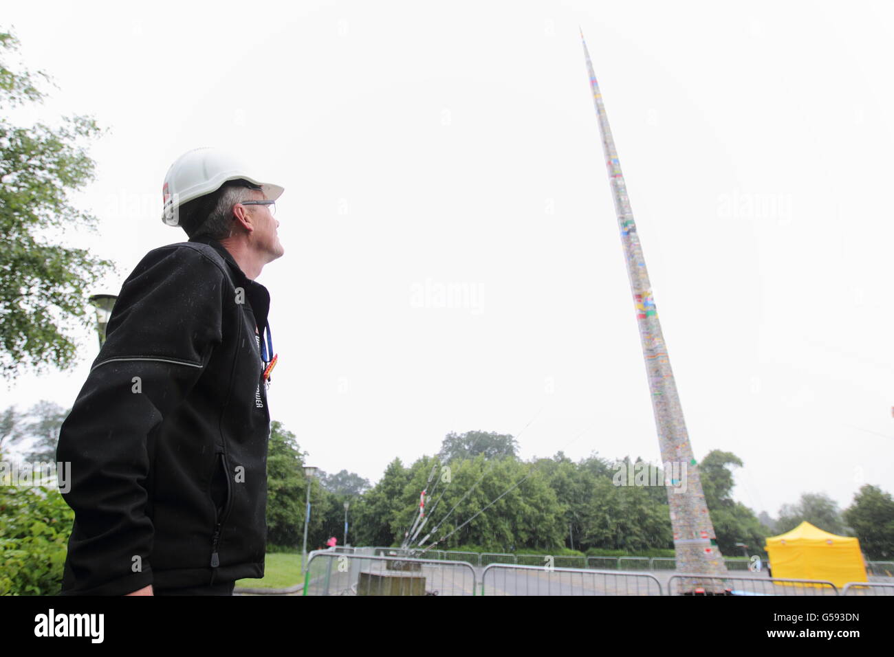 A worker looks to the top of the worlds tallest LEGO tower at the ...