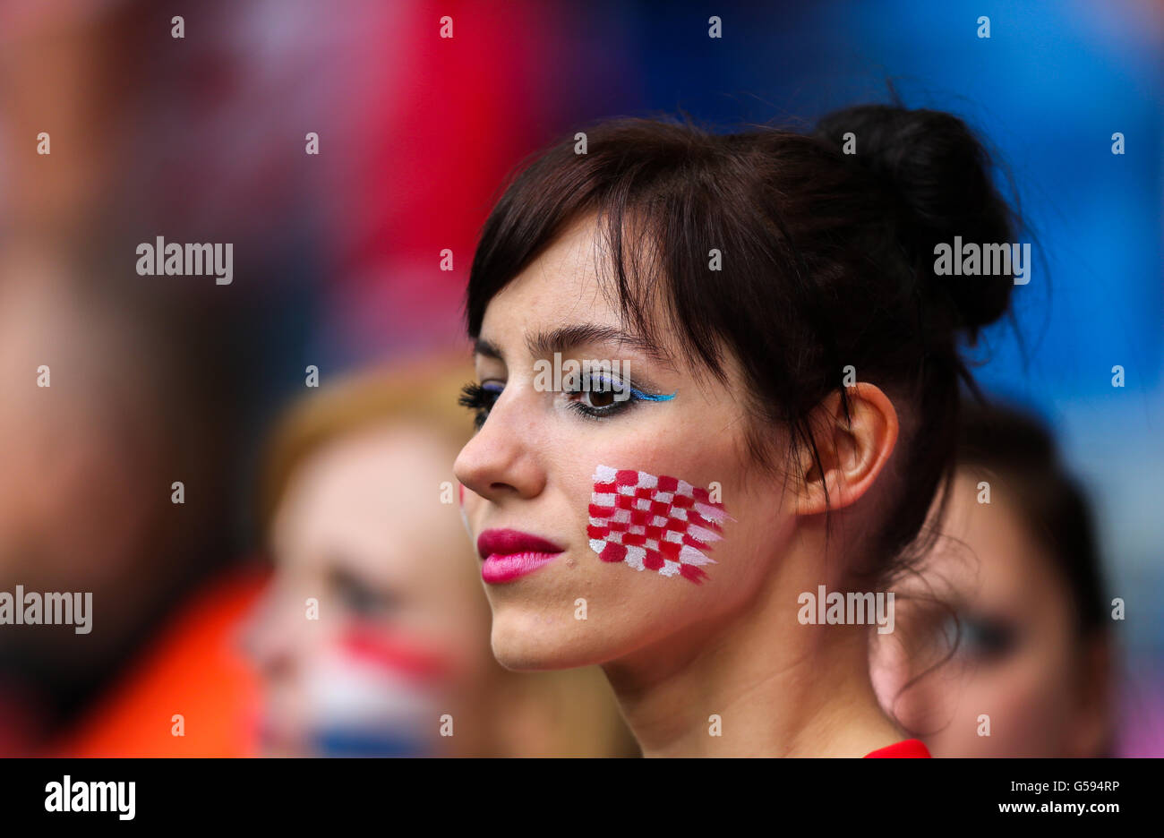 A Croatian flag bearer with her face painted in the national colours ...