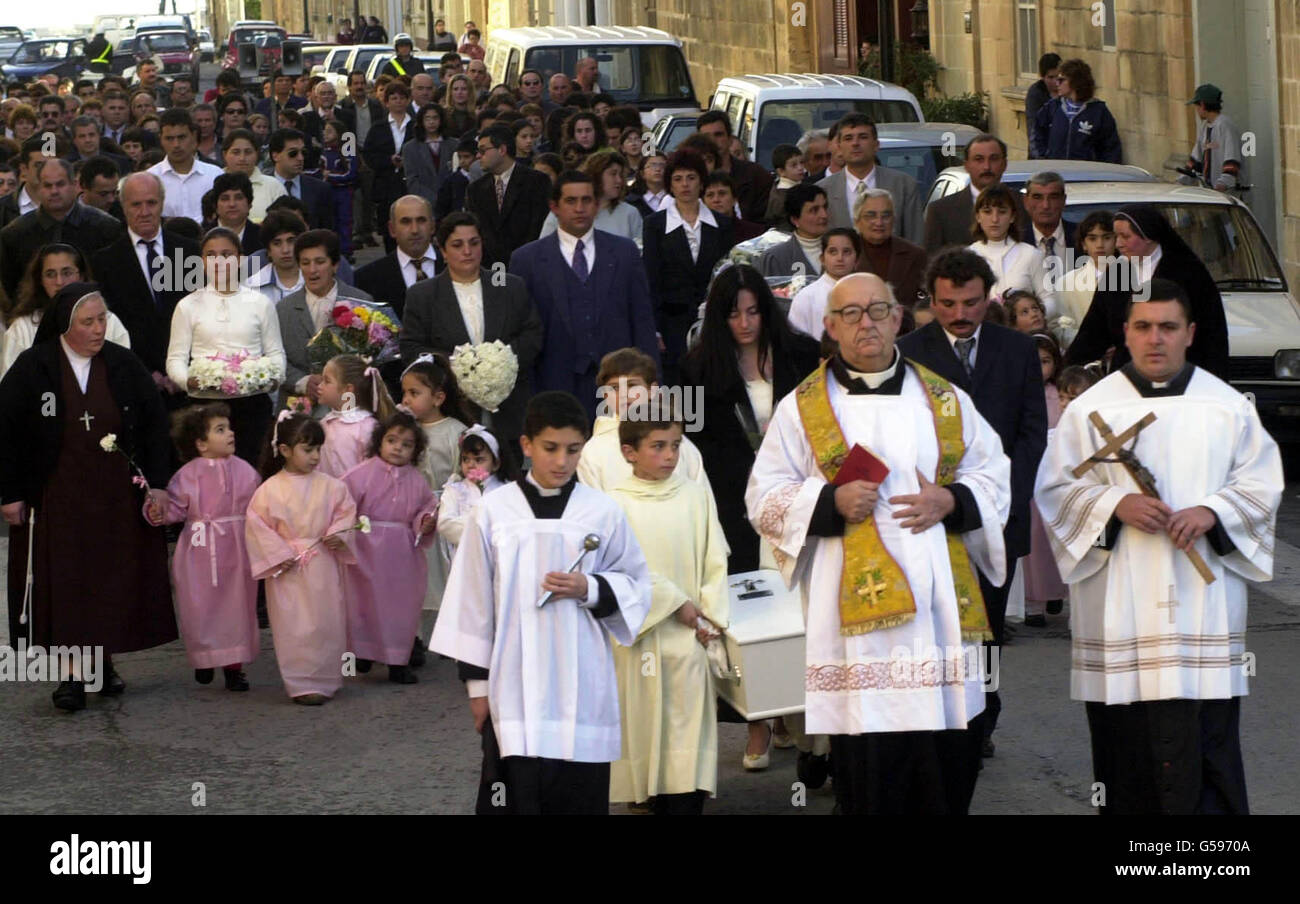 Michaelangelo Attard, 44, and his wife Rina, 29 (behind priests) joined ...