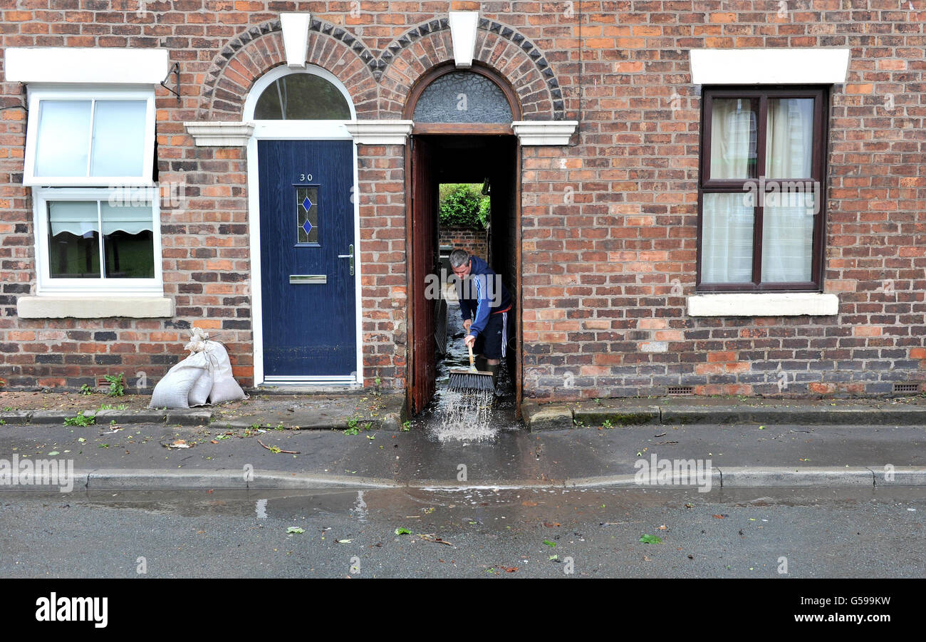 Tom burke clear flood water from his house in croston hi-res stock ...
