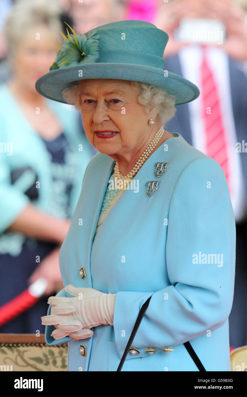 Queen Elizabeth II watches a flotilla of boats celebrating the history ...