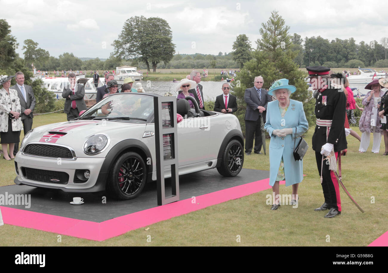 Queen Elizabeth II walks past a Mini during a visit to the Henley ...