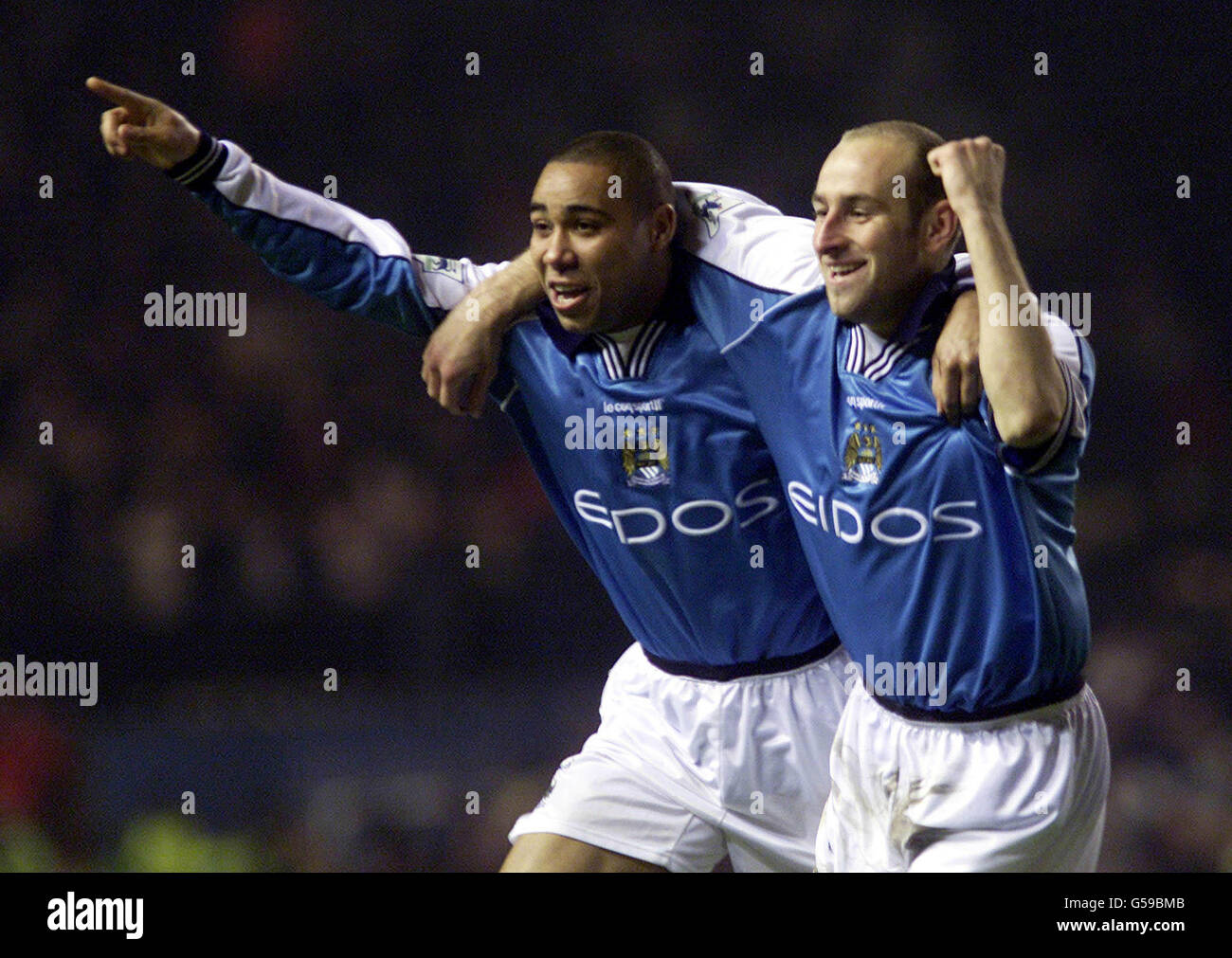 Manchester City's Danny Tiatto (R) celebrates scoring City's equaliser ...