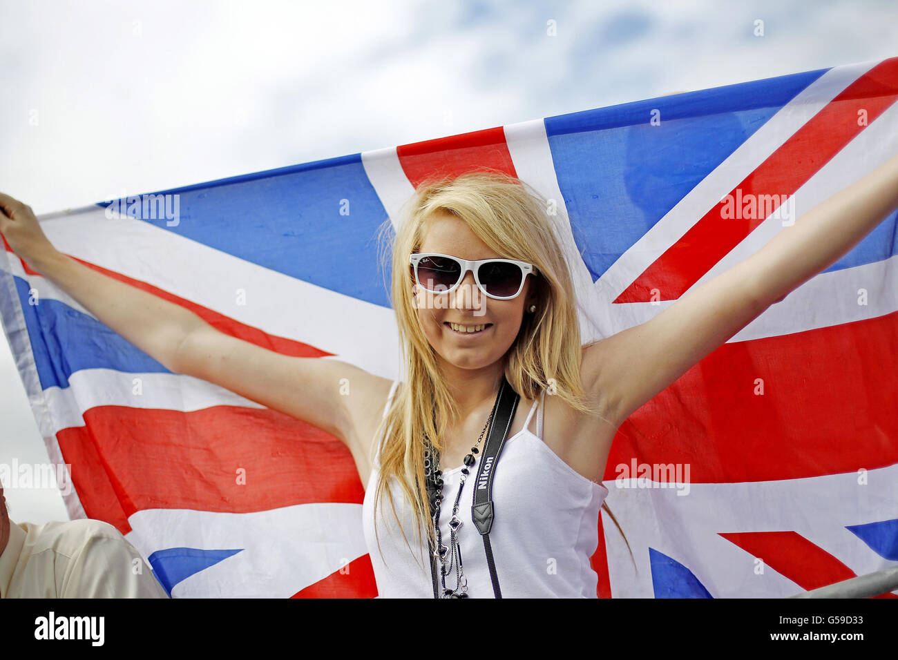 A young girl with a Union flag waits in the grounds of the Stormont ...