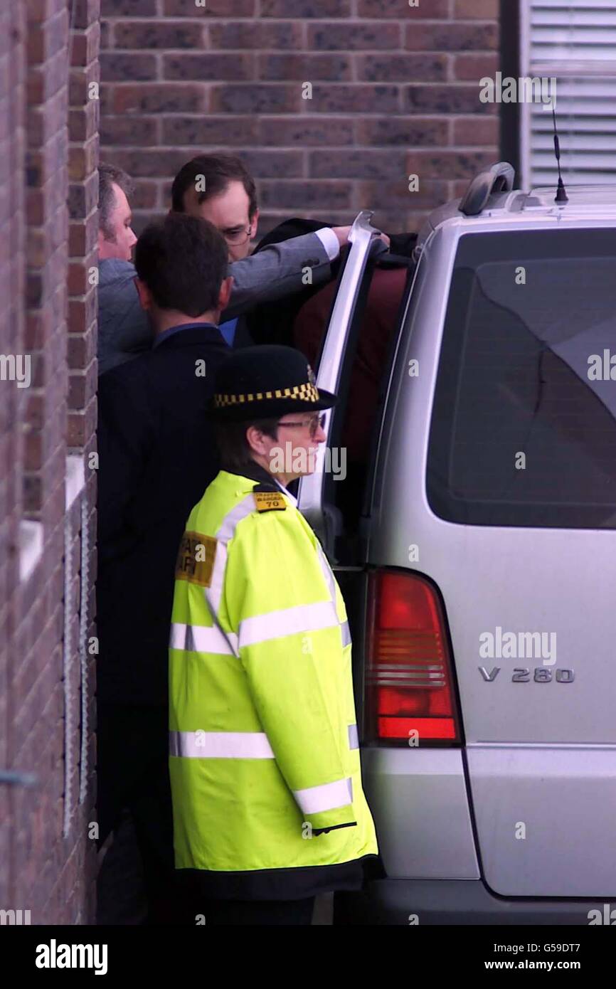 Roy Whiting arrives at Bognor Regis Police Station under a blanket, as ...