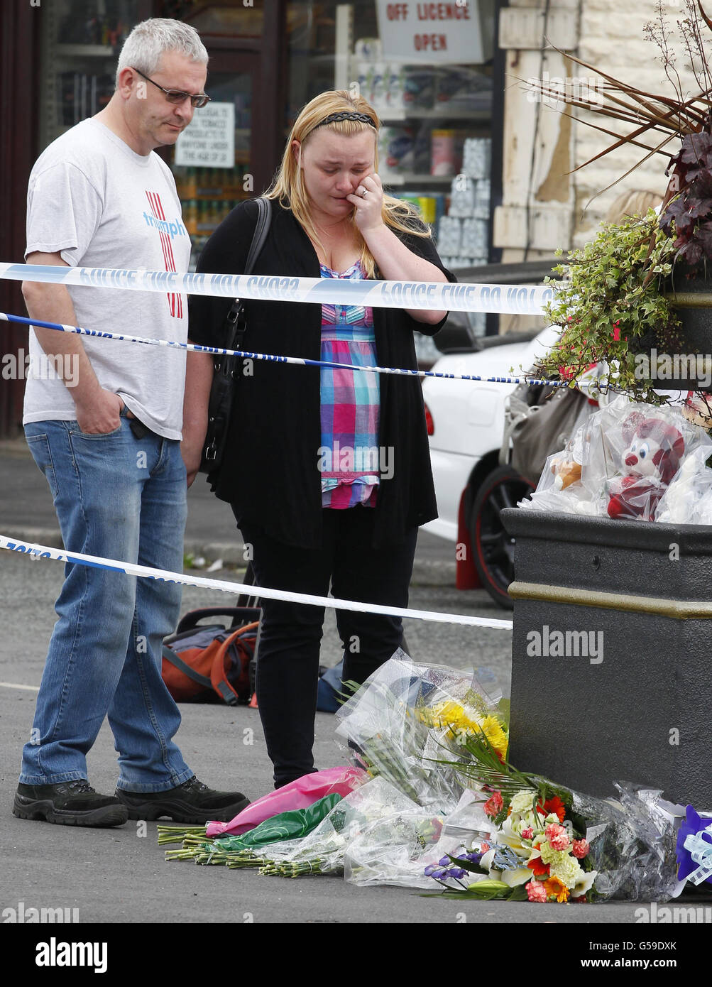 Family friends of Jamie Heaton (names not given) stand alongside floral ...