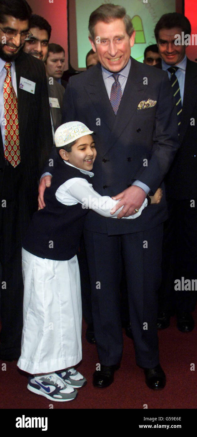 The Prince of Wales gets a hug from eight year-old Abrar Nurani as he ...