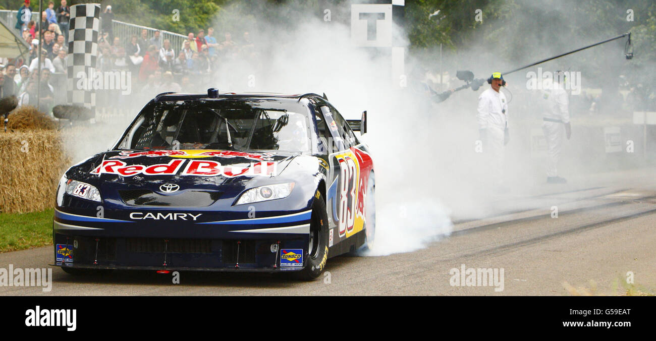 A Toyota NASCAR engulfs marshalls in tyre smoke at the annual Goodwood ...