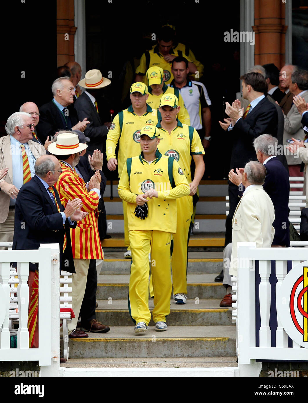 Australia captain Micael Clarke leads his team out between the MCC ...