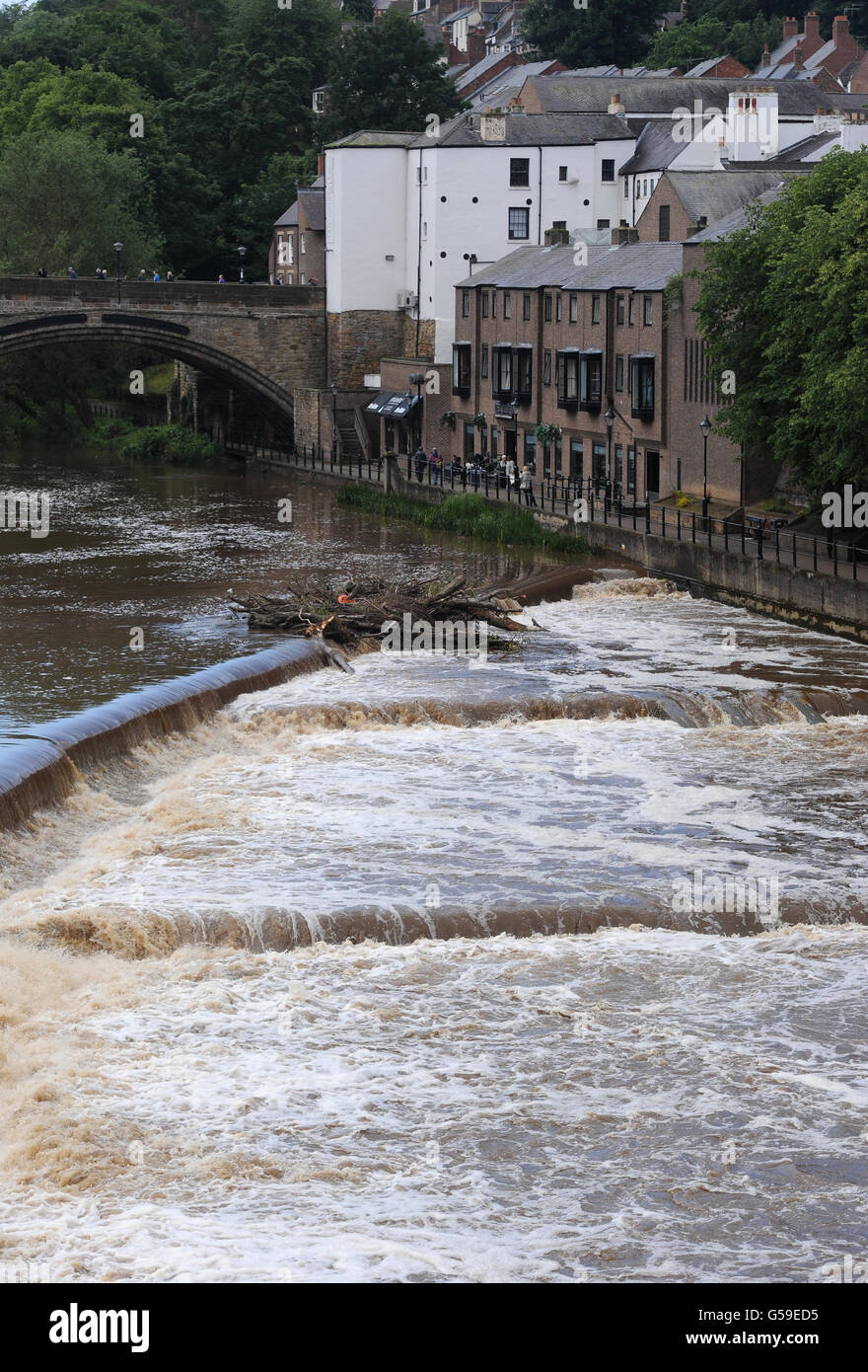 People look out over the fast flowing River Wear in Durham today after ...