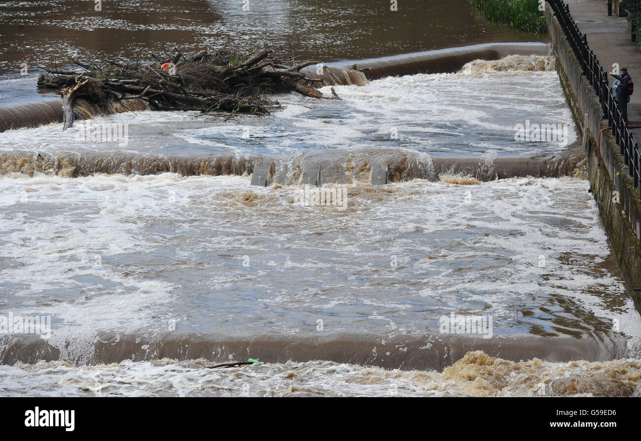 People look out over the fast flowing River Wear in Durham today after ...
