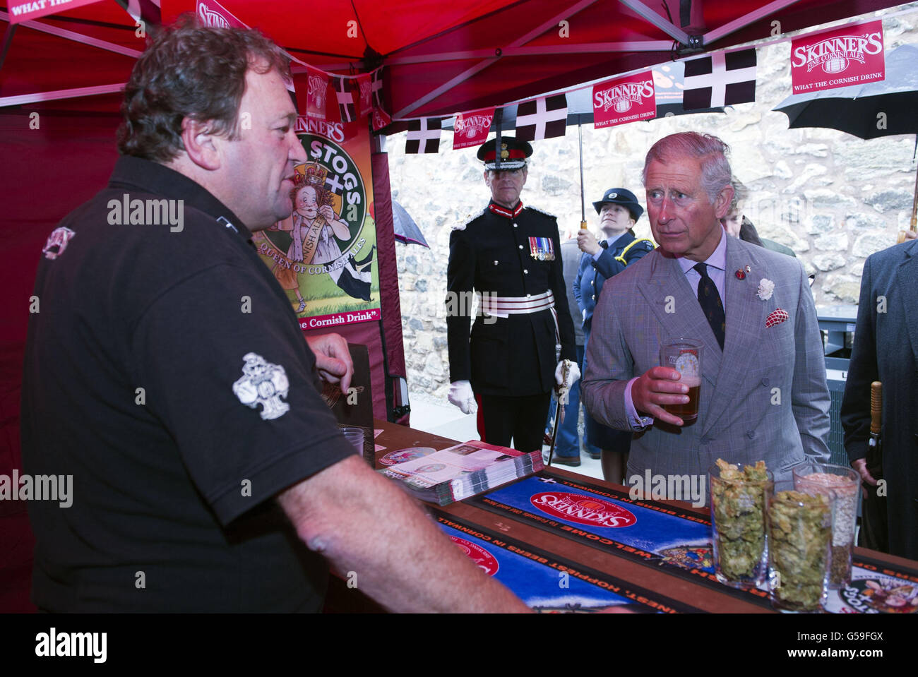 The Prince of Wales drinks a pint of Betty Stogs Cornish Ale during a ...