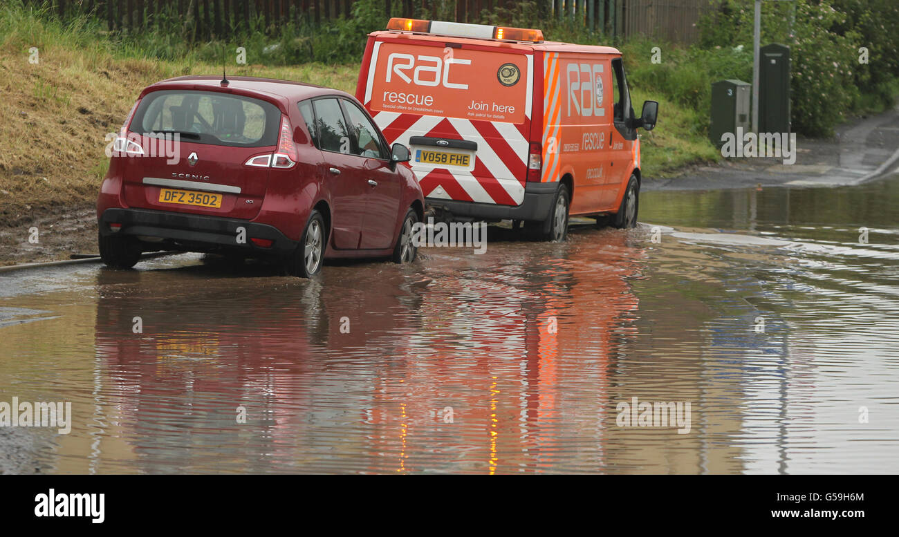 An RAC breakdown van is used to recover a vehicle from a flooded street ...