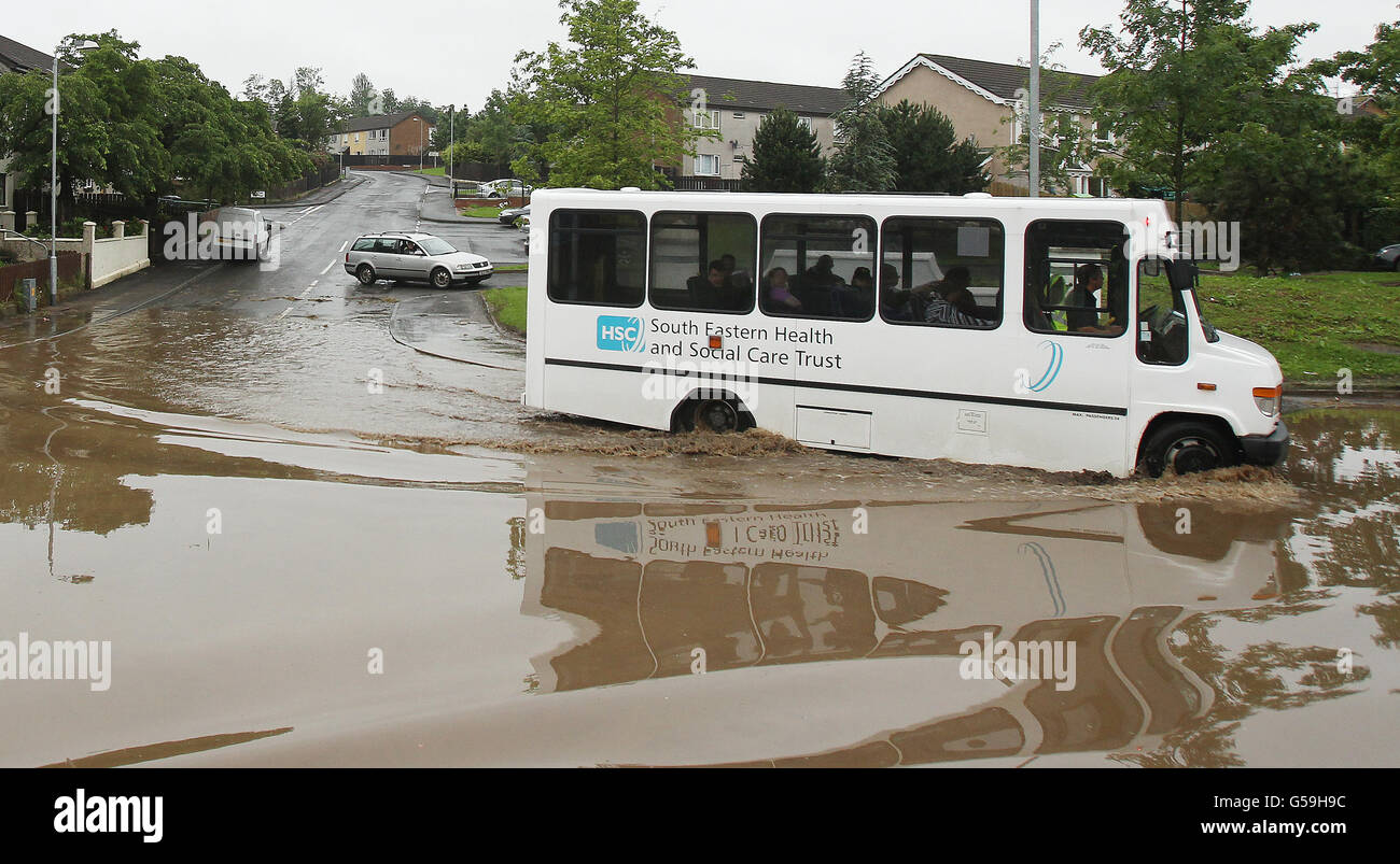 Amber warning after severe floods. A bus driver drives his bus through ...