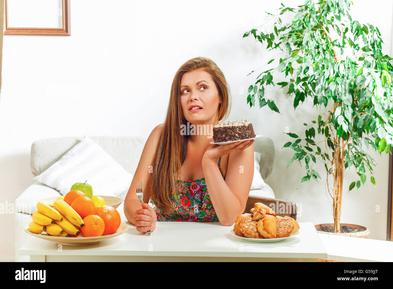 Fat woman sitting at table home Stock Photo - Alamy