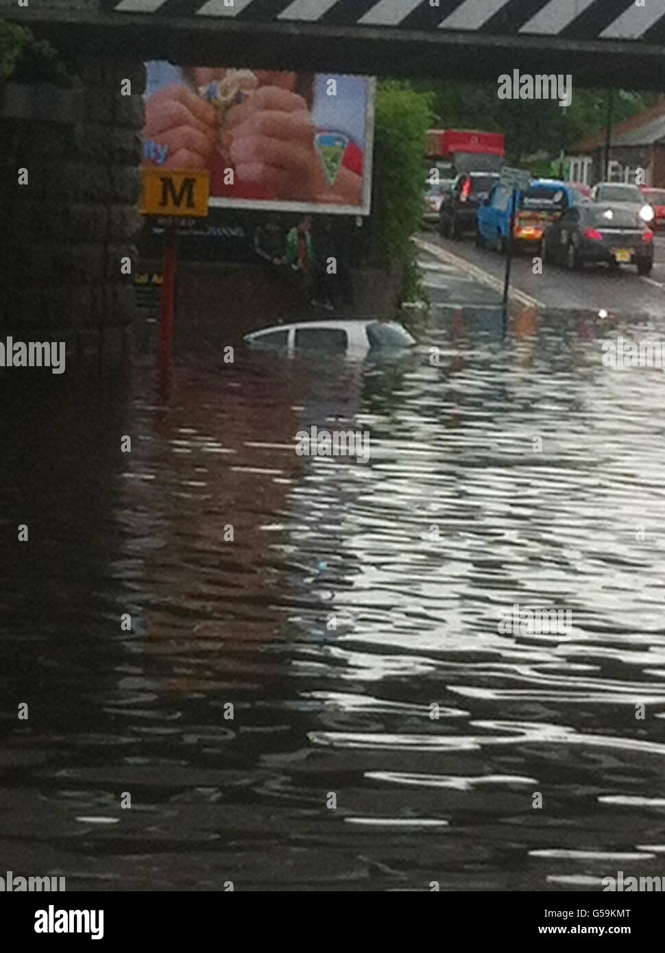 A car is seen abandoned in flood water under the Metro bridge at ...